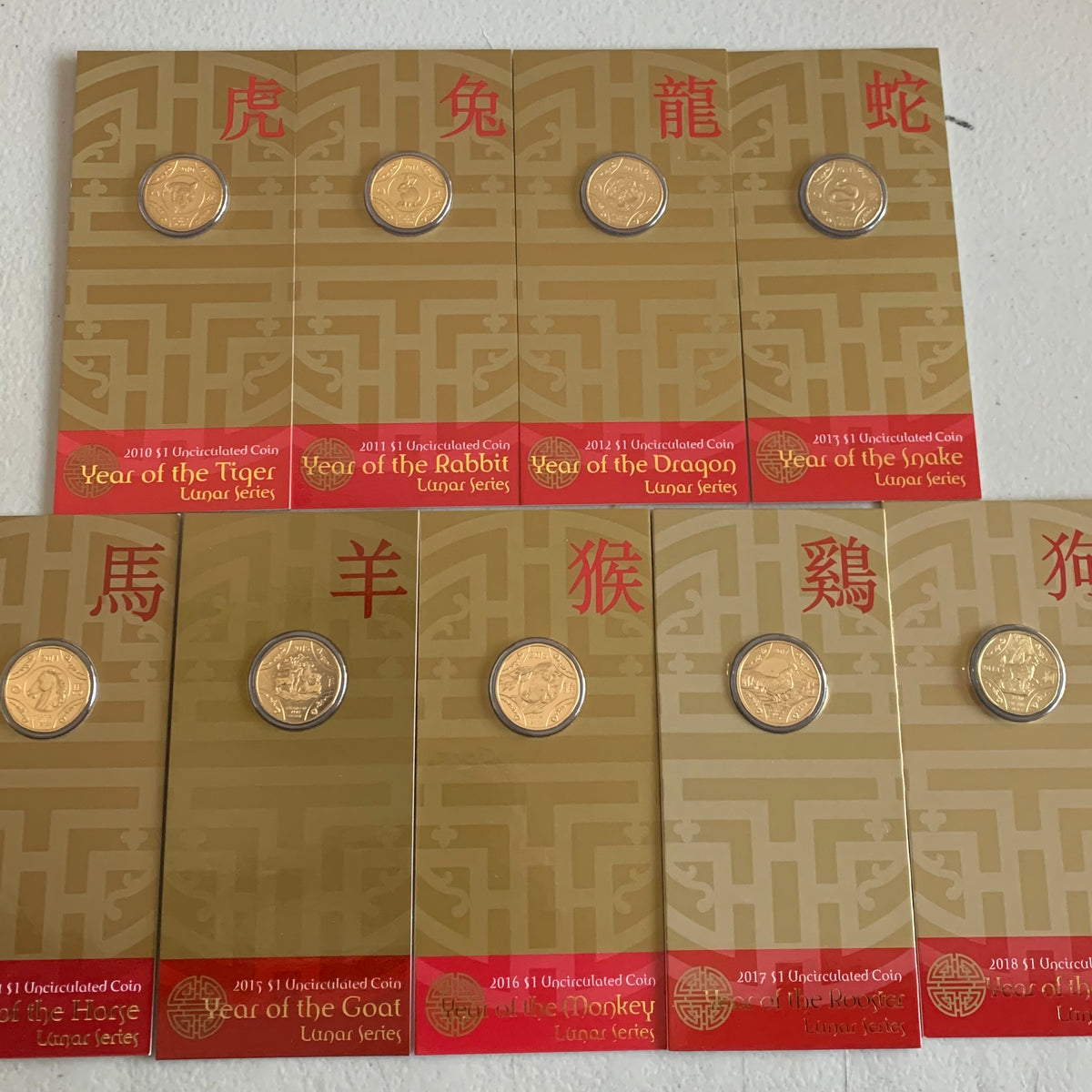 2010-2018 Set Of 9 Lunar $1 Uncirculated Carded Coins. – Ensleigh Coins